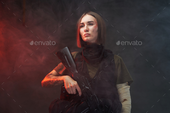 Beautiful martial woman with rifle in smokey and dark background Stock ...