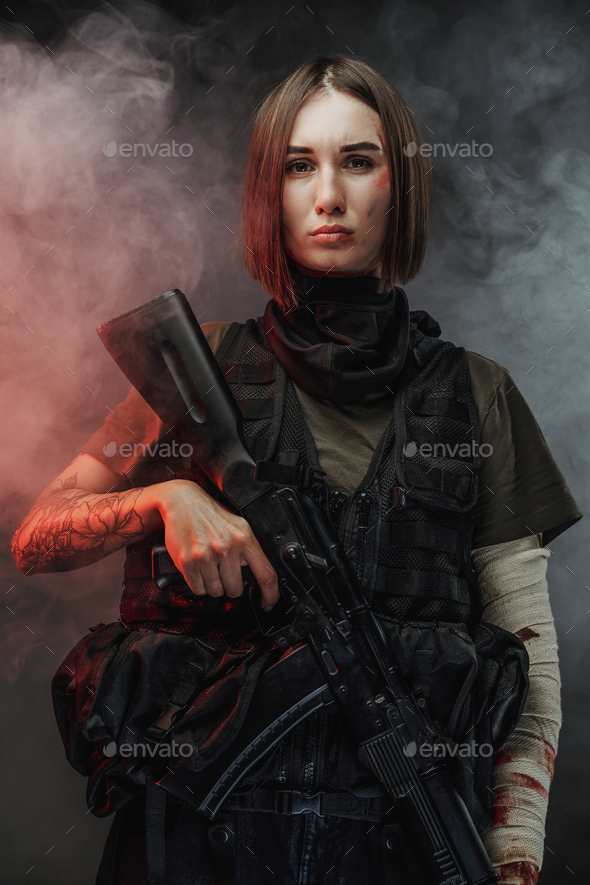 Serious martial woman with rifle poses in smokey dark background Stock ...