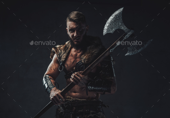 Evil legendary viking holding two handed axe in dark background Stock ...