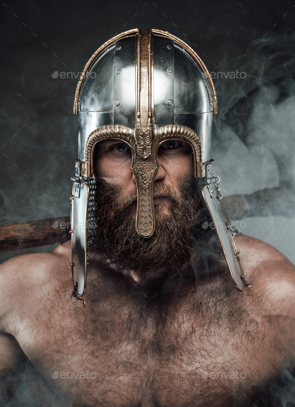 Viking posing in smoke with axe behind his back Stock Photo by fxquadro