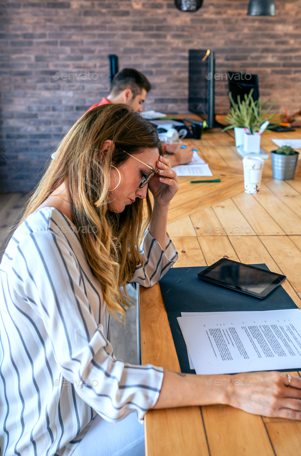 Businesswoman looking document in the office Stock Photo by davidpereiras