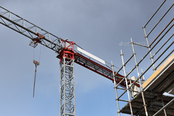 Crane and scaffold on construction site Stock Photo by formatoriginal