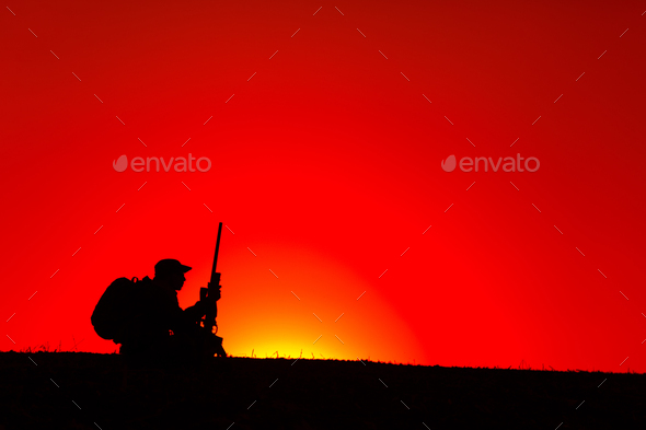 Sniper, hunter siting on hill with rifle on sunset Stock Photo by ...