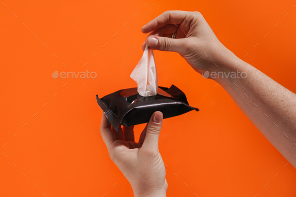 Woman's hands using wet wipes isolated Stock Photo by vadymvdrobot