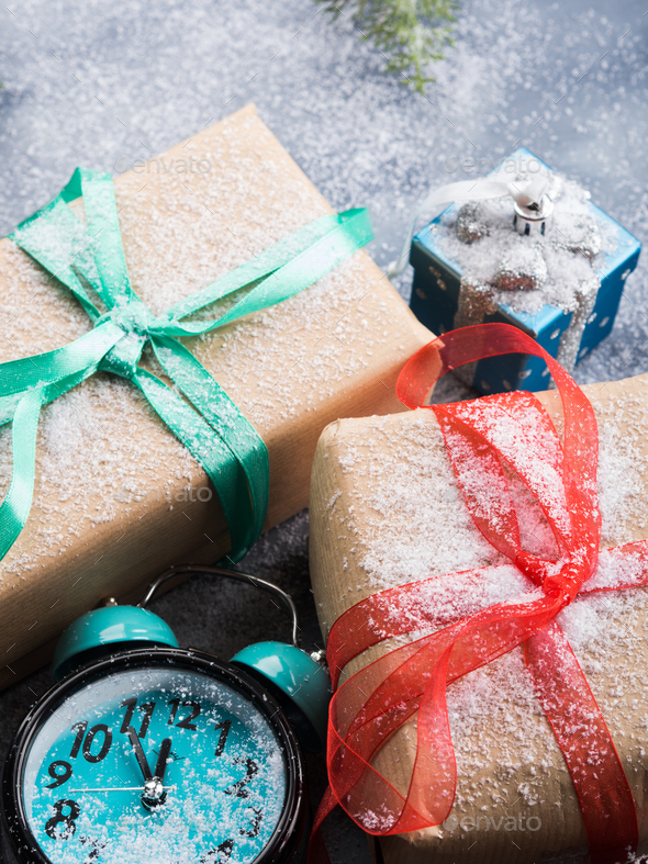 Christmas gifts with ribbons and snow. Clock Stock Photo by tenkende