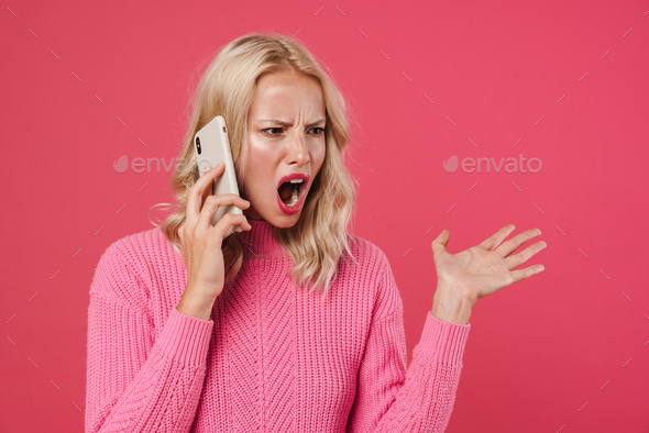 Image of furious blonde girl screaming while talking on mobile phone ...