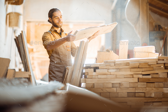 Carpenter at the wood storage Stock Photo by RossHelen | PhotoDune