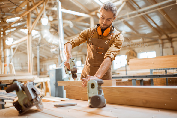 Carpenter working with cordless tools at the workshop Stock Photo by ...