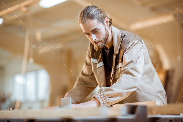 Carpenter working at the carpentry manufacturing Stock Photo by RossHelen