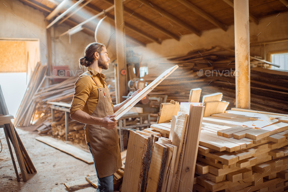 Carpenter at the wood storage Stock Photo by RossHelen | PhotoDune
