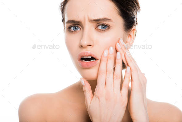 surprised brunette girl touching cheek isolated on white Stock Photo by ...