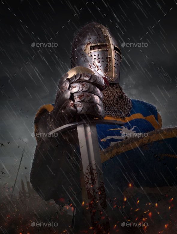 A knight with sword under the rain on battlefield. Stock Photo by fxquadro