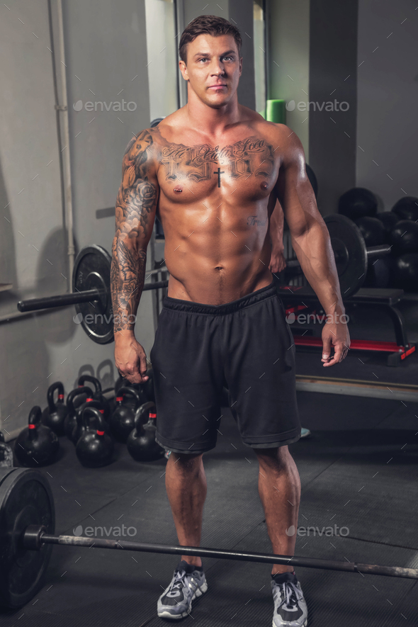 Tattooed muscular man in a gym club. Stock Photo by fxquadro | PhotoDune
