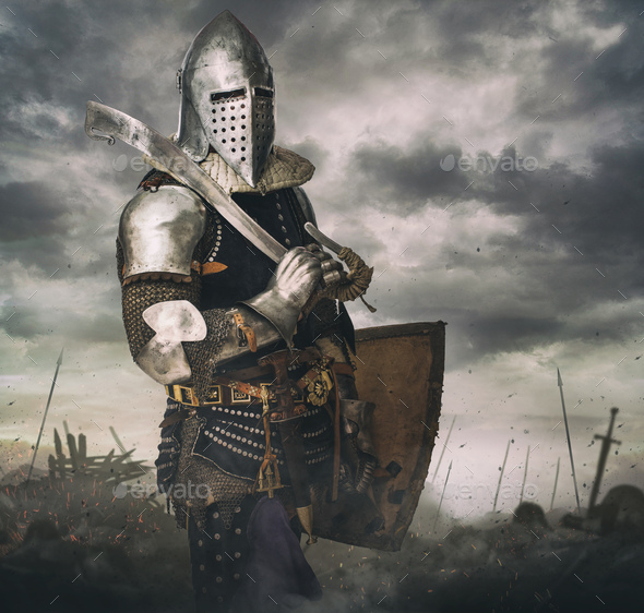 Knight in armour on battle rise under stormy sky. Stock Photo by fxquadro