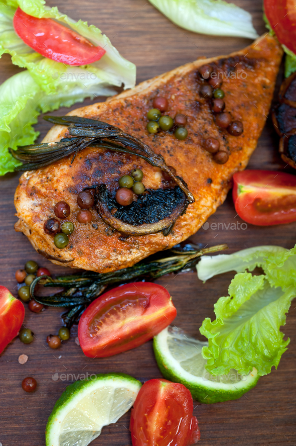 wood fired hoven cooked chicken breast on wood board Stock Photo by keko64