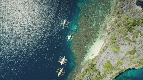 Top down of traditional boats at rock ocean coast aerial view. Majestic ...