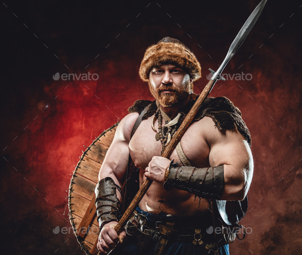 Strong and shirtless viking with spear in dark red background Stock ...
