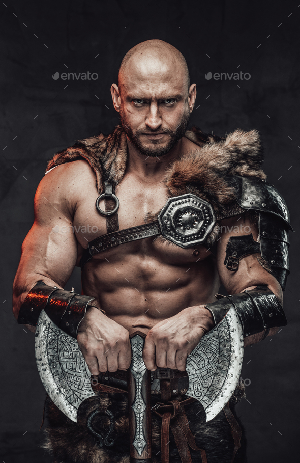 Serious bald viking posing in dark background with double axe Stock ...