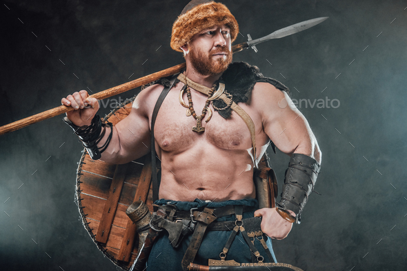 Scandinavian warrior with spear poses in foggy background Stock Photo ...