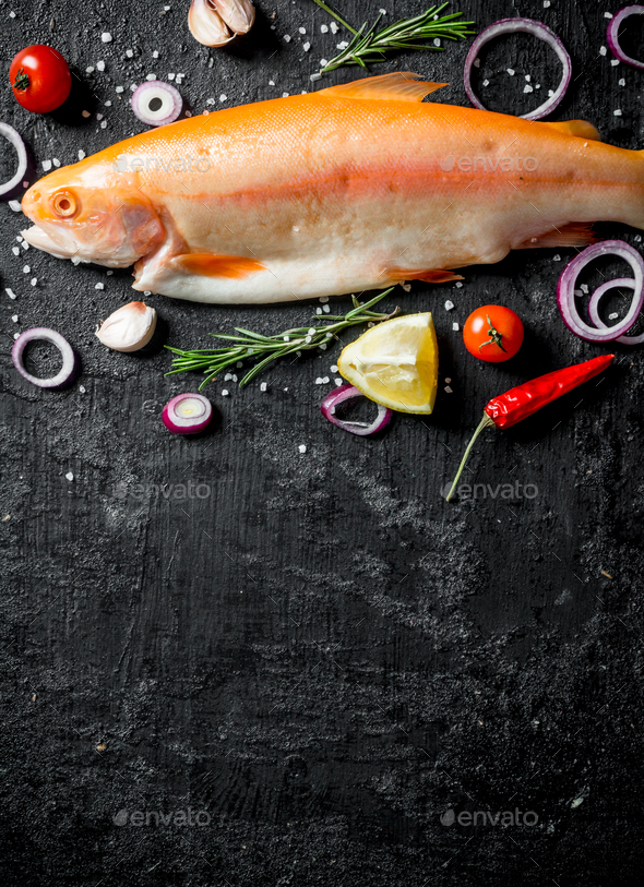 Raw trout fish with onion rings, lemon and chili pepper. Stock Photo by ...