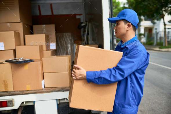 Delivery man loading truck Stock Photo by DragonImages | PhotoDune