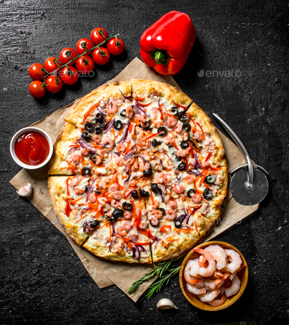 Sea pizza with bell peppers, tomatoes and shrimp. Stock Photo by Artem_ka2
