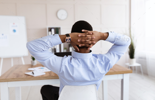 Back view of black businessman sitting at workplace in office Stock ...
