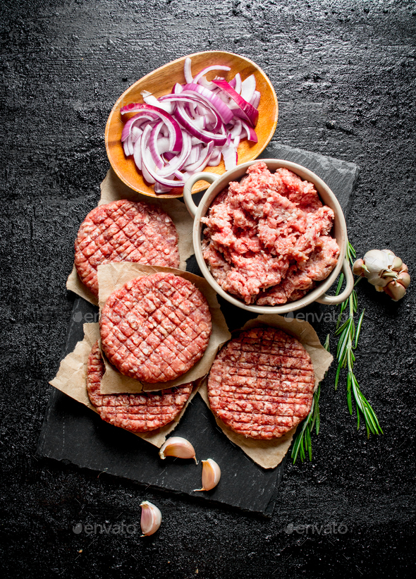Raw burgers with ground beef and sliced onions in bowls. Stock Photo by ...