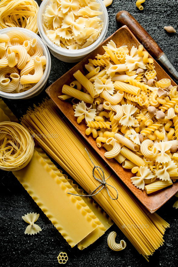 Different types of dry pasta on the plate and in bowls. Stock Photo by ...