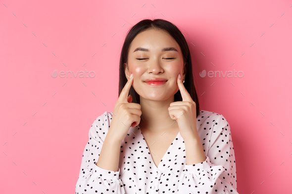 Beauty and lifestyle concept. Close-up of beautiful asian woman poking ...
