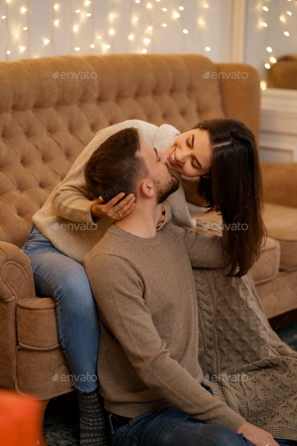 Happy positive young couple embracing relaxing sit on sofa Stock Photo ...