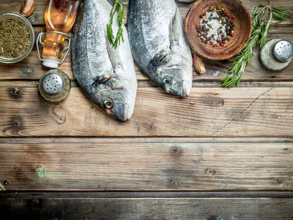 Raw sea fish with aromatic herbs and spices. Stock Photo by Artem_ka2