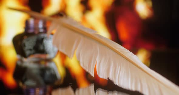 A White Quill Pen With An Ink Bottle On Fire Place Background, Stock ...