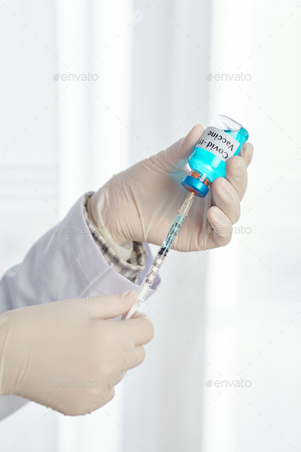 Getting ready to inject vaccine Stock Photo by DragonImages | PhotoDune