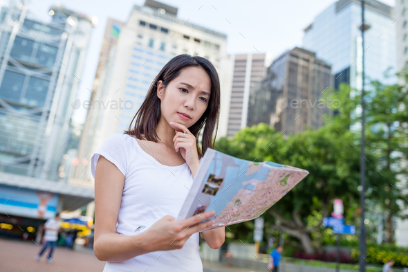 Woman use paper map to find location Stock Photo by leungchopan | PhotoDune