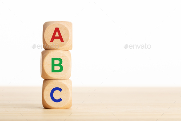 ABC letters alphabet in wooden blocks stacked on wood table Stock Photo ...