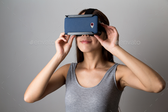 Young Woman using the virtual reality equipment Stock Photo by leungchopan