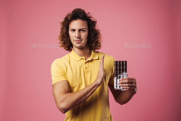 Serious man refusing eating chocolate isolated Stock Photo by vadymvdrobot