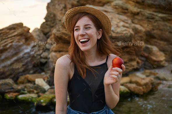 Portrait of young ginger nice freckles lady on the beach, wears hat ...