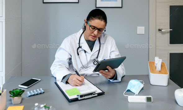 Female doctor doing online consultation with the tablet Stock Photo by ...
