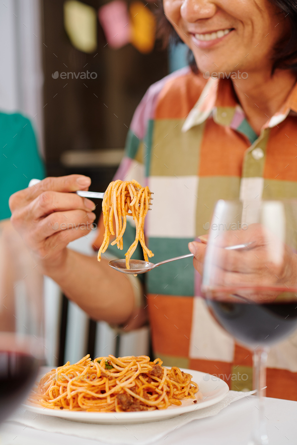 Man eating spaghetti bolognese Stock Photo by DragonImages | PhotoDune