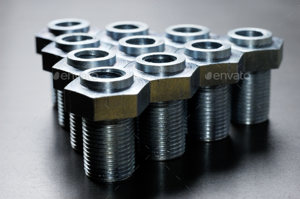 Close-up of several chrome metal bolts Stock Photo by YouraPechkin