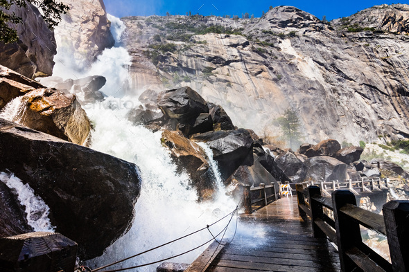Wapama Falls flowing over the footbridge Stock Photo by SundryPhotography