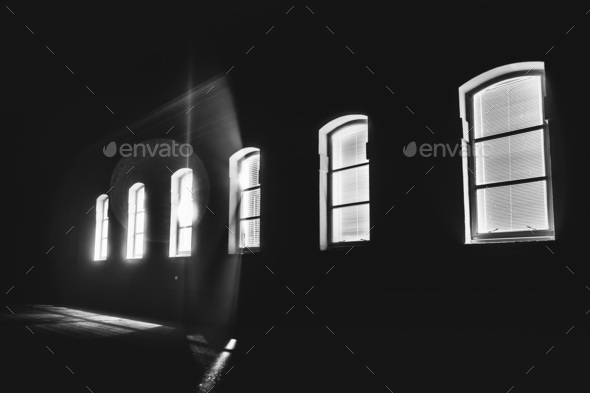Bright light shinning through a row of windows in the middle of the ...