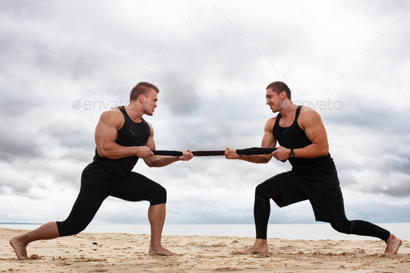 Bodybuilders on the beach Stock Photo by Microstock_Growth | PhotoDune