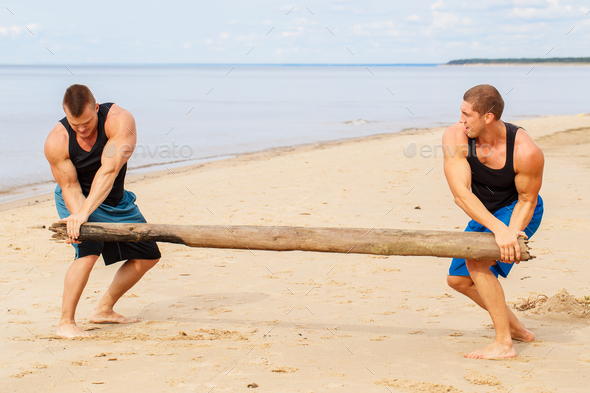 Bodybuilders on the beach Stock Photo by Microstock_Growth | PhotoDune