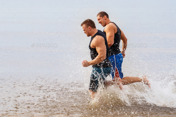 Bodybuilders on the beach Stock Photo by Microstock_Growth | PhotoDune