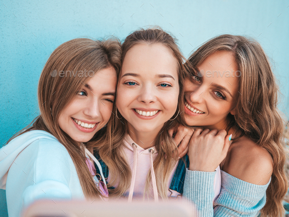 Portrait of three young beautiful women posing outdoors Stock Photo by ...