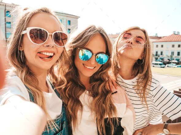 Portrait of three young beautiful women posing outdoors Stock Photo by ...