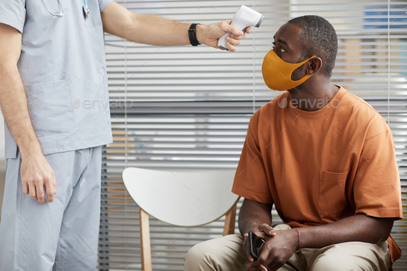 Temperature Check in Clinic Stock Photo by seventyfourimages | PhotoDune